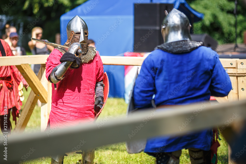 medieval jousting knight fight, in armor, helmets, chain mail with axes ...