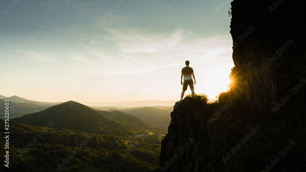 Man Standing Alone On Cliff