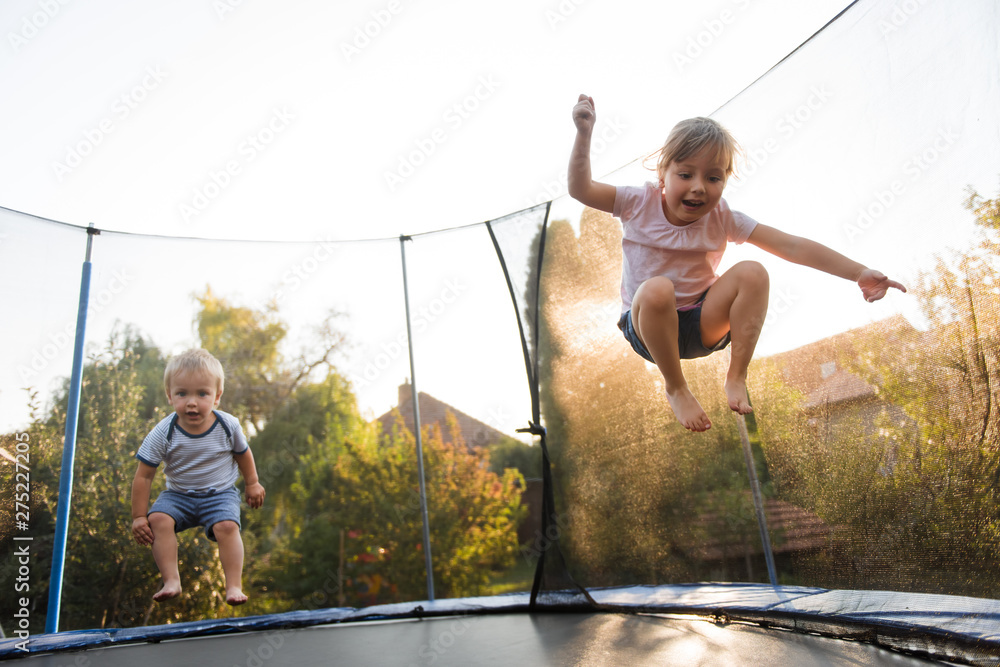 Kids jumping high on trampoline Stock Photo | Adobe Stock