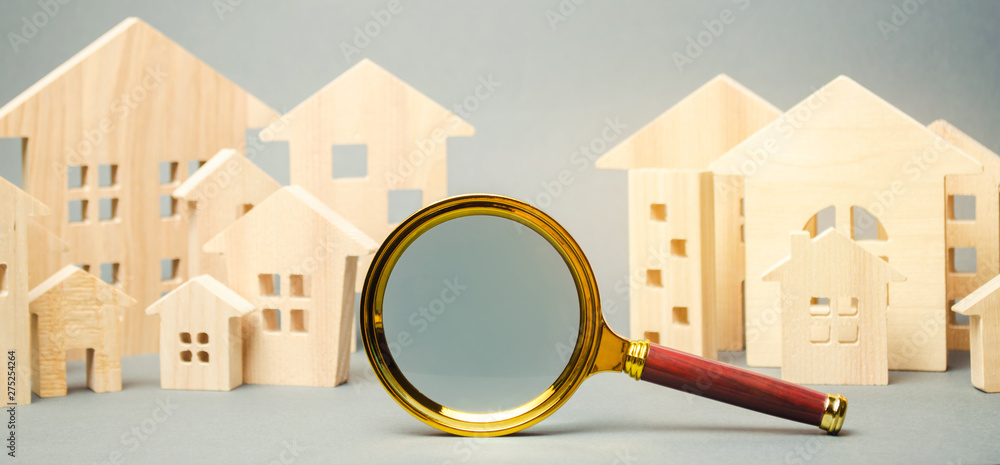 Magnifying glass and wooden houses. House searching concept. Home ...