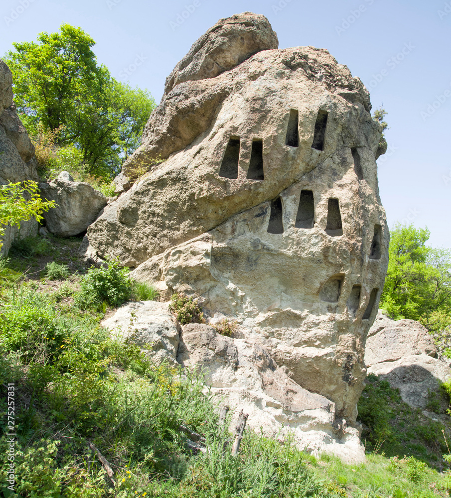 Thracian trapezoidal rock-cut niches on survey rock over the village ...