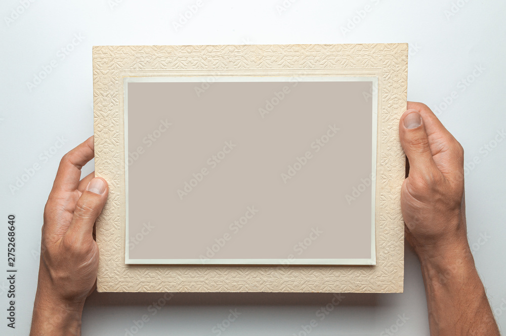 Old photo in frame in the hands of man. Empty template for picture ...