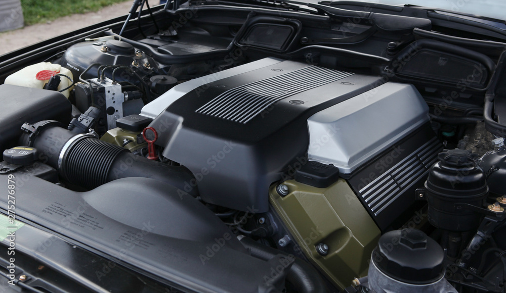 New modern powerful car engine close up view. Covered with black ...