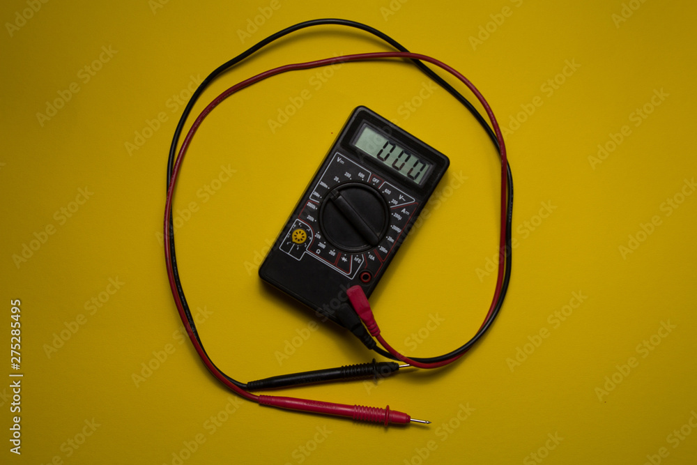 Digital meter meter multimeter on a yellow background. digital ...