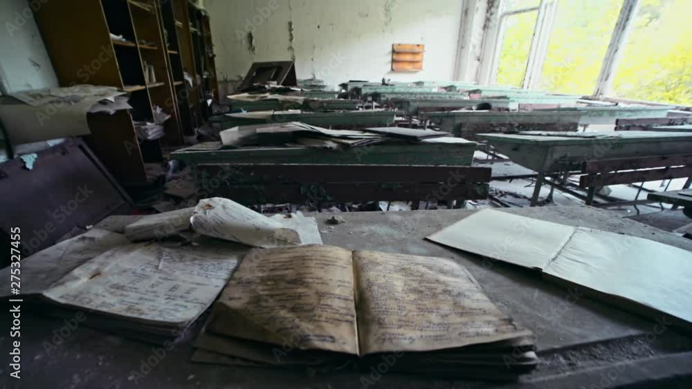 Close-up of students books lying on the shabby desk in the abandoned ...