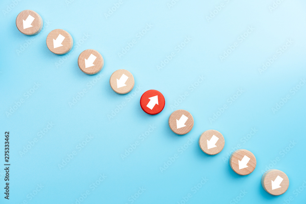 Red wooden block with arrow facing individual pointing in the different ...