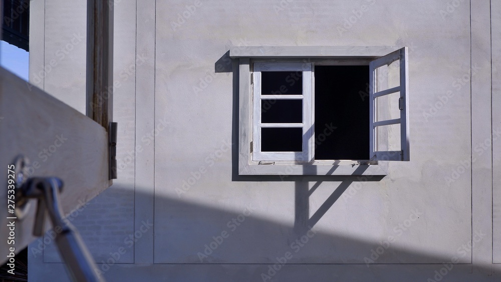 Sunlight and shadow on surface of white wooden window on gray concrete ...
