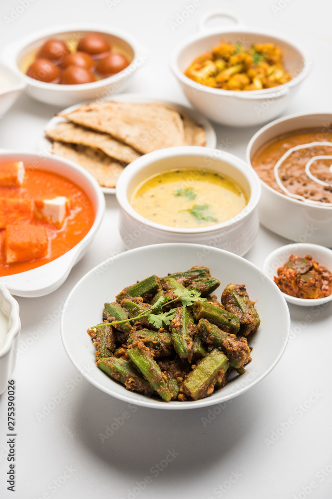 Assorted Indian food like paneer butter masala, dal, roti, rice, sabji ...