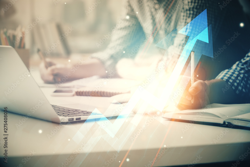 Growing arrows with businessman working on computer on background ...