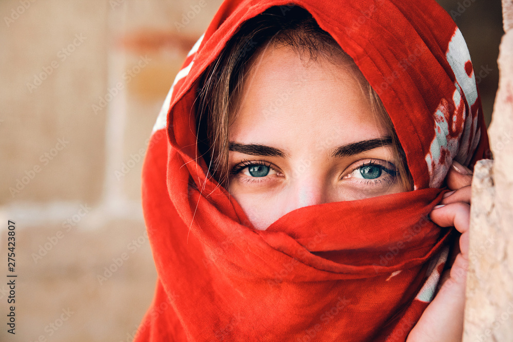 Portrait of an arabic young woman with her beautiful blue eyes in ...
