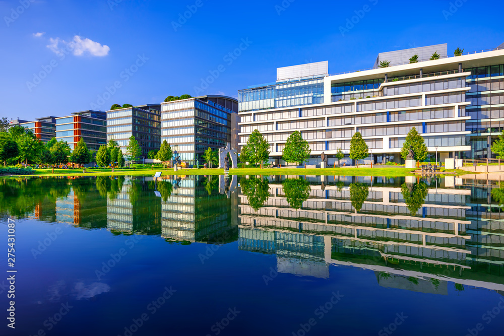 Urban landscape with modern office buildings, reflection on water ...