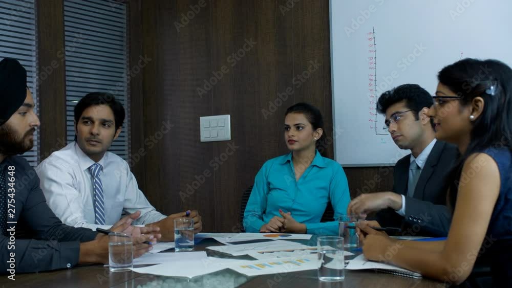 Indian colleagues discussing their upcoming projects and investment ...