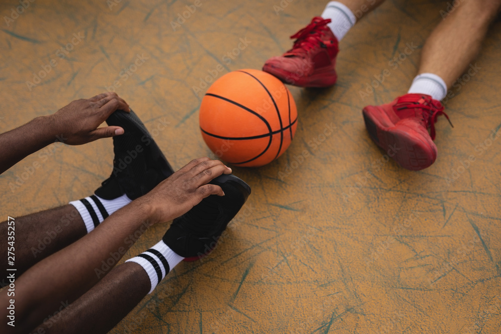 Basketball players warming up before game in basketball court Stock ...