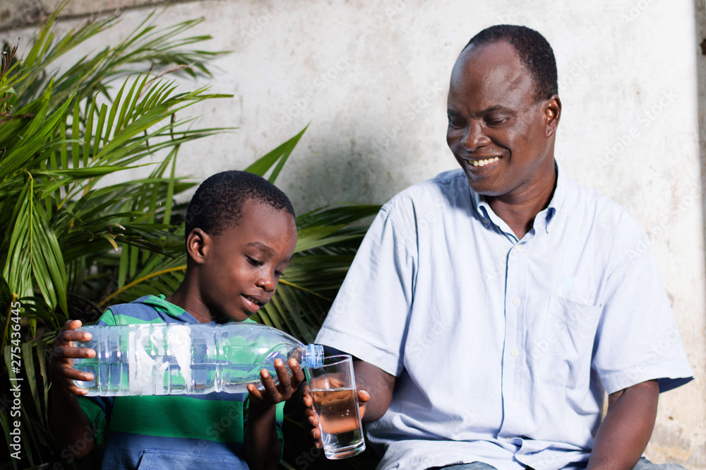 child out of the water in a glass to his smiling father Stock Photo ...