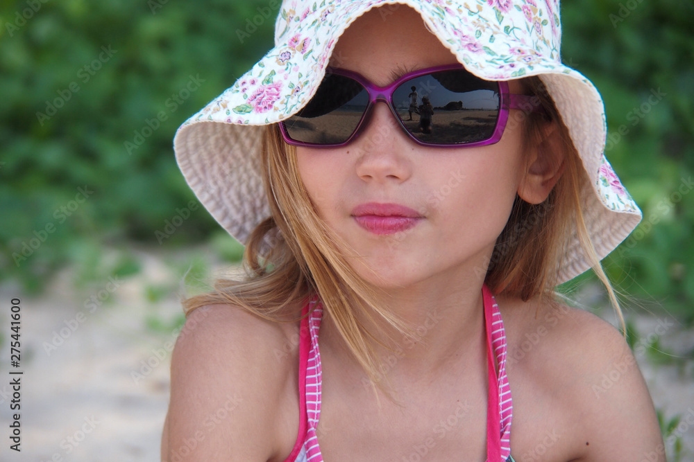 Portrait Of An Eight year old Girl Wearing Sunglasses And A Hat Stock portrait-of-an-eight-year-old-girl-wearing-sunglasses-and-a-hat-stock