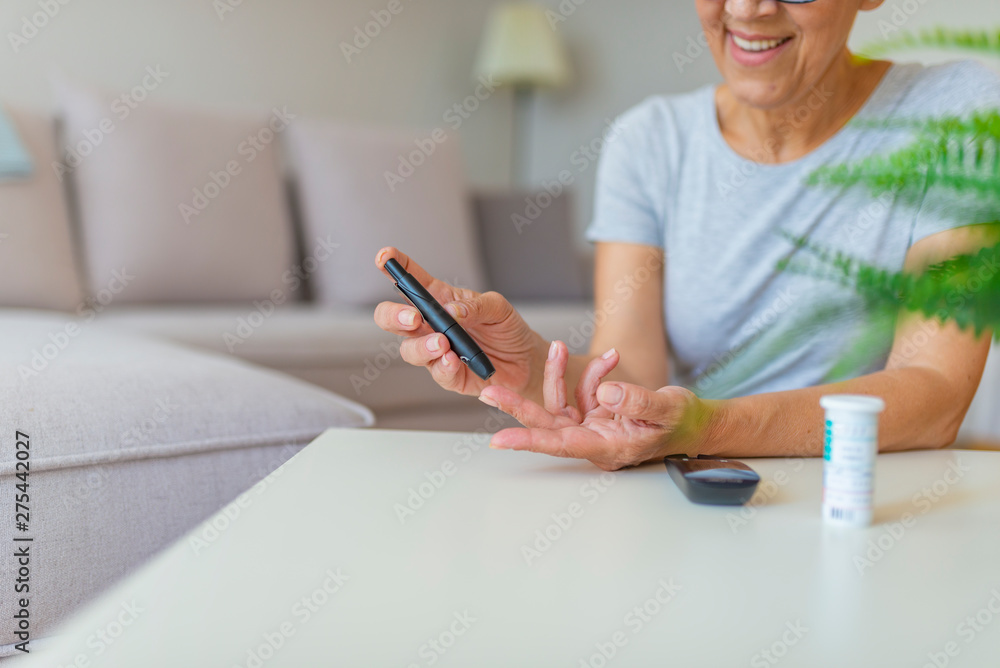 Close-up photo with a woman who is testing her level of glucose in her ...