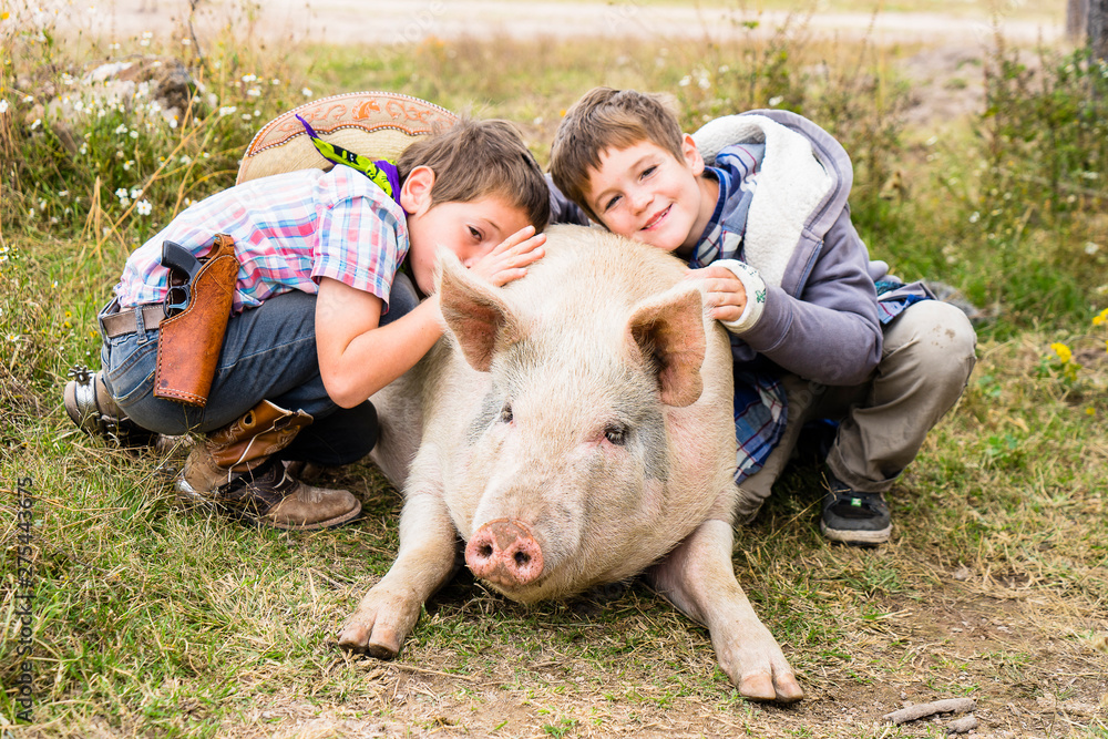 Two kids cuddling a pig, Rancho La Joya, Ranch John Wayne, Durango ...