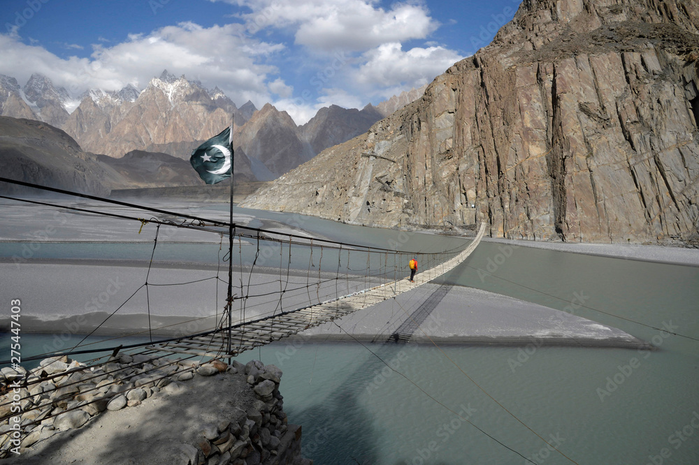 Pakistan, Gilgit Baltistan area, Passu, a man is crossing the Hunza ...
