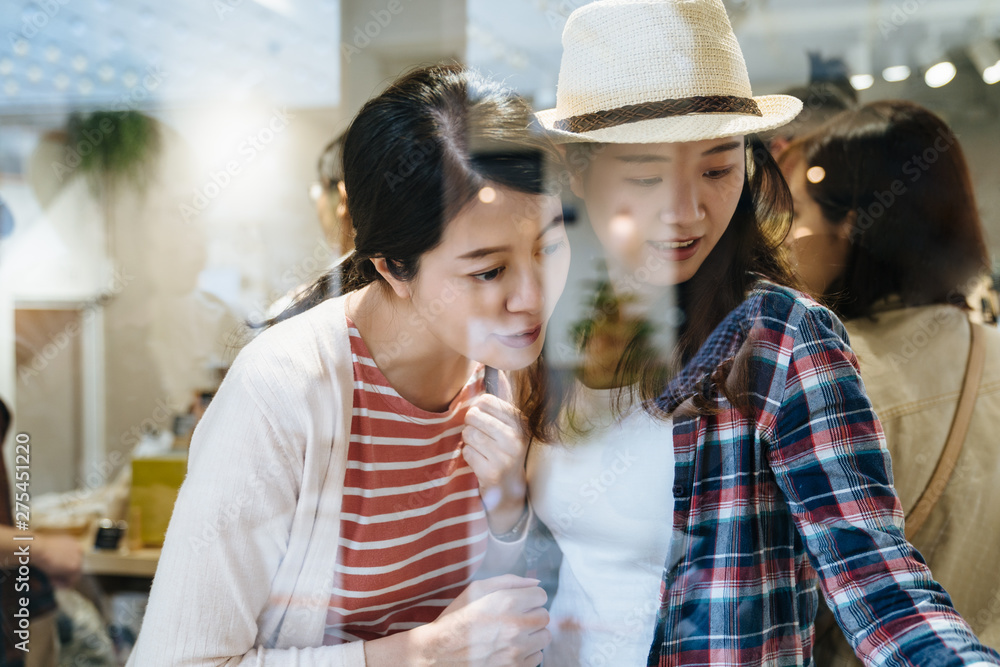shot through window case real moment lifestyle concept. two asian women ...