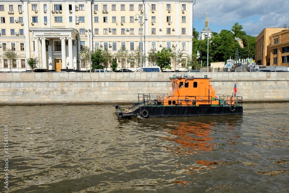 River cleaning boat collects garbage on water surface of river.Trash ...