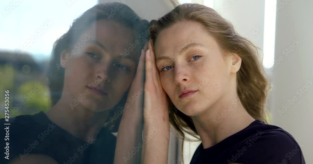 Portrait close-up of a young beautiful light girl who poses leaning ...