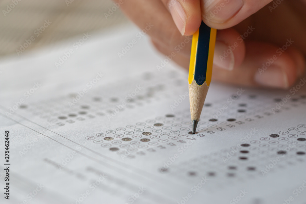 School or university students hands taking exams, writing examination ...
