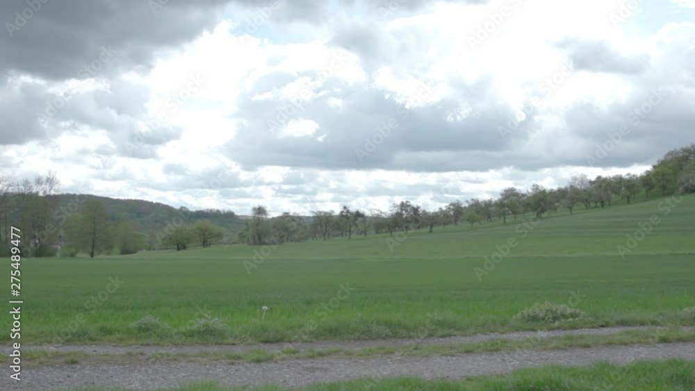 [Static, slow motion] Classic guitar is tossed through the air from ...