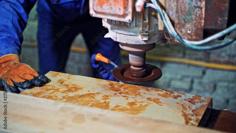 Worker cutting stone block. Industrial worker making horizontal cut ...