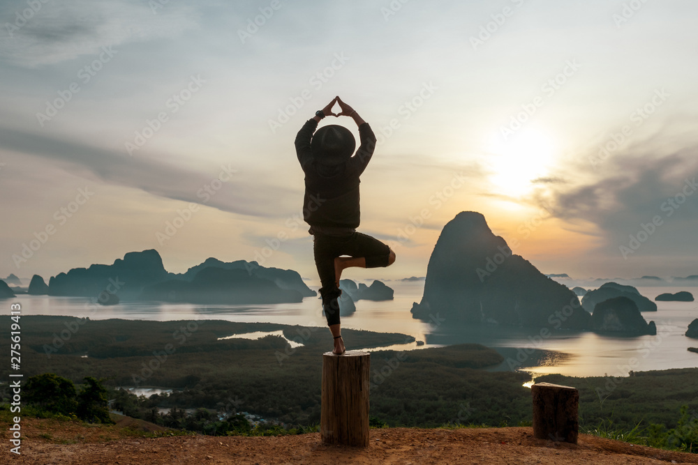 Back view of a Yoga pose. Happy man in black clothes doing yoga pose ...