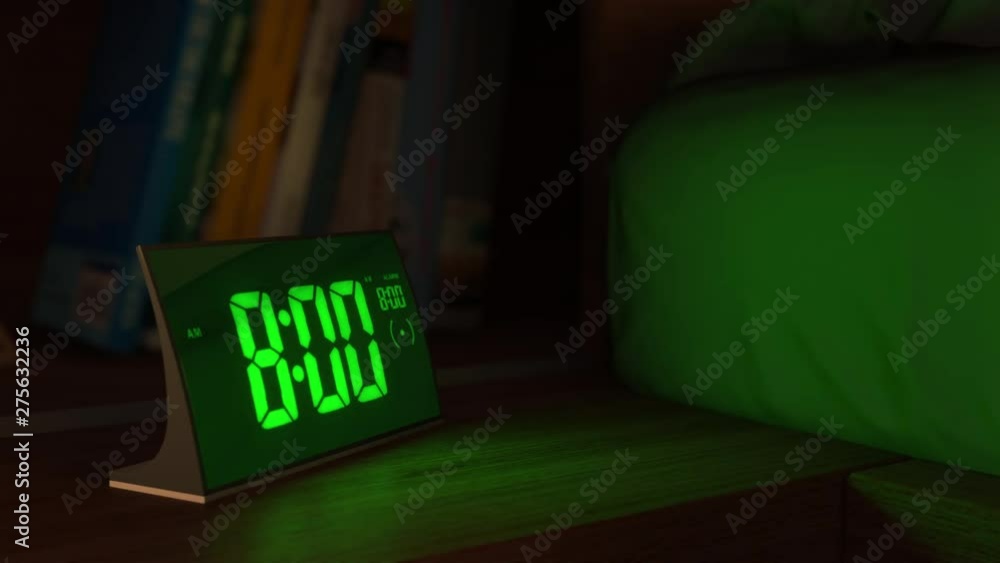 Digital alarm clock in a bedroom waking up at 8 AM. Close-up view. The ...