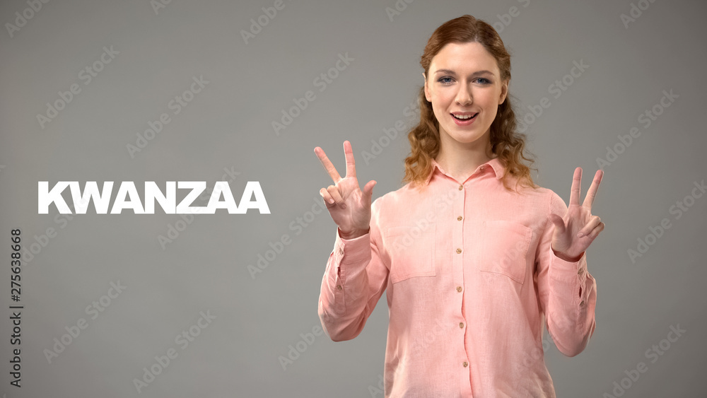 Deaf lady saying kwanzaa in sign language, text on background ...