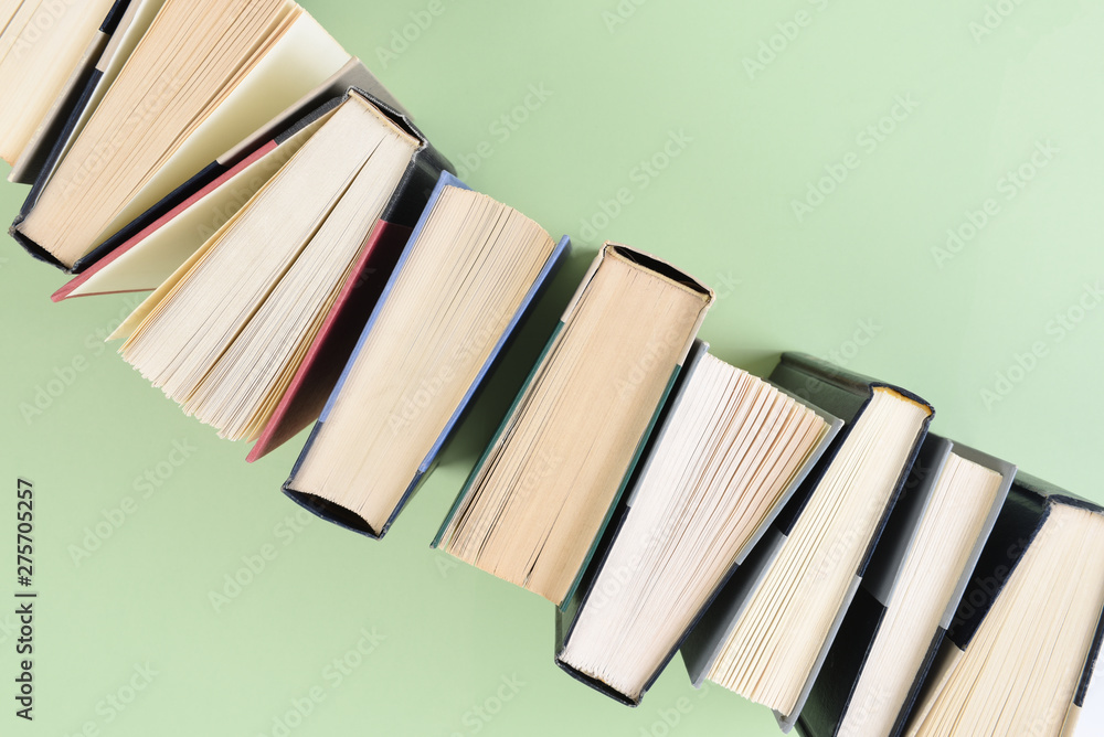 A line of books standing on end running at an angle form one corner of ...
