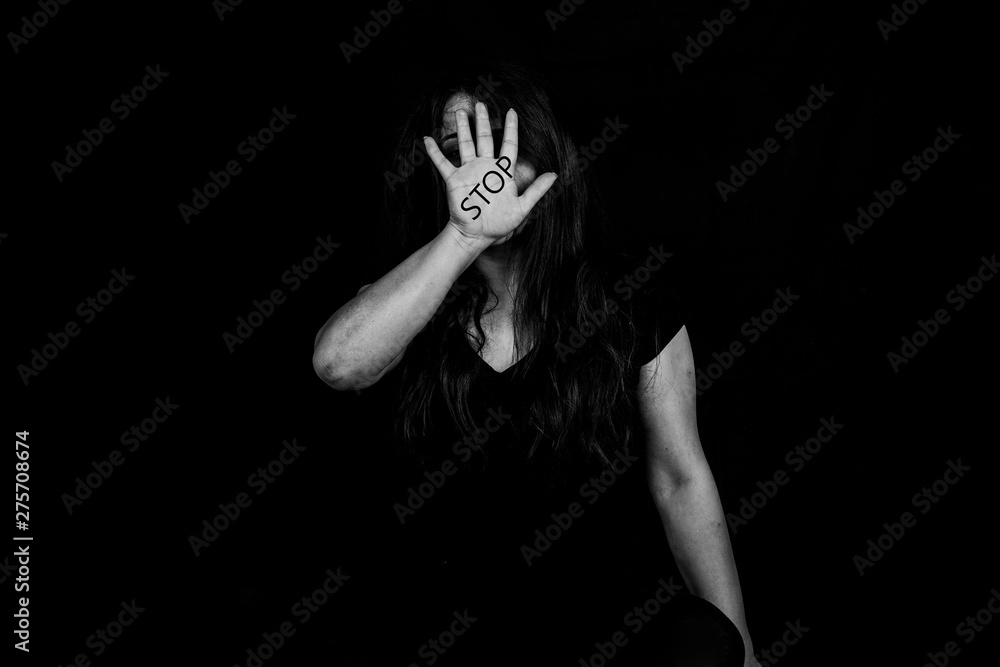 Stopping violence against women, Woman covering her face in fear of ...