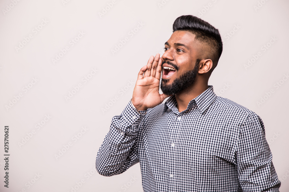 An angry indian man pulling his hair and screaming, isolated on a white ...