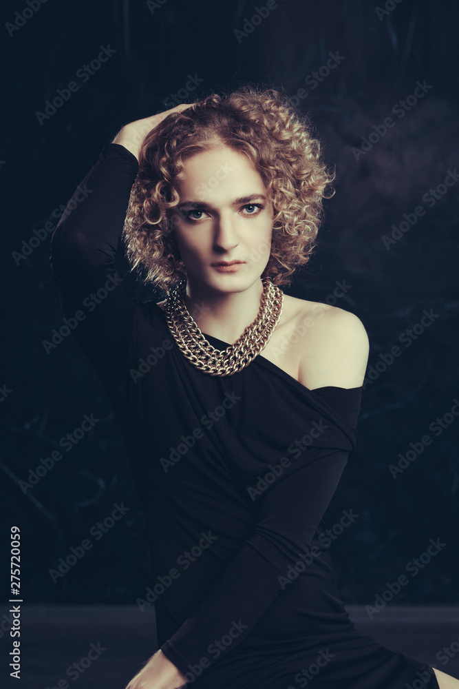 A semi-profile portrait of transgender guy model with blue eyes and ...