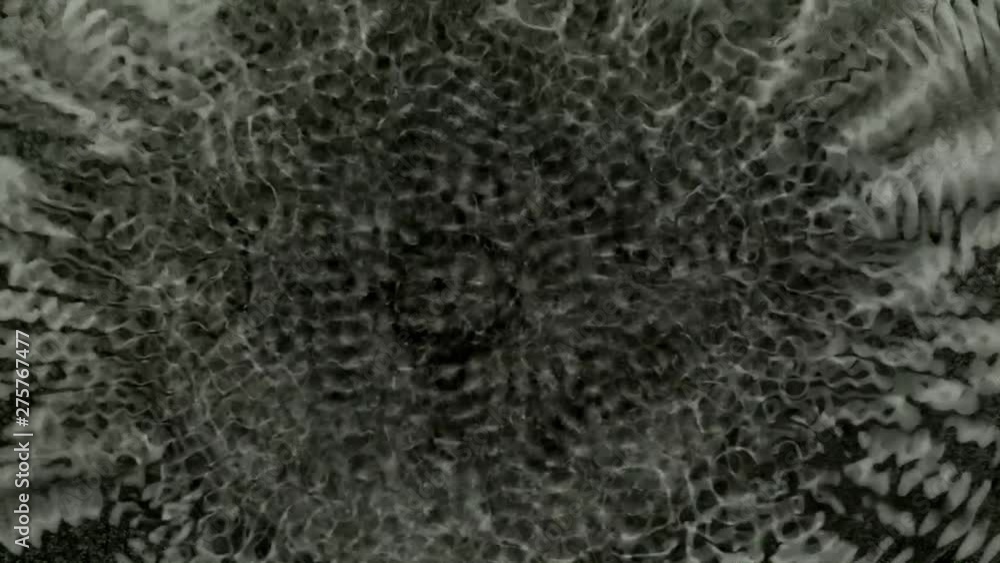 Water forming cymatic patterns and reflecting light. Fluid surface ...