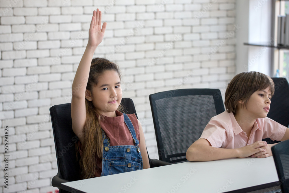Cute Children girl student raising hands in classroom at school ...