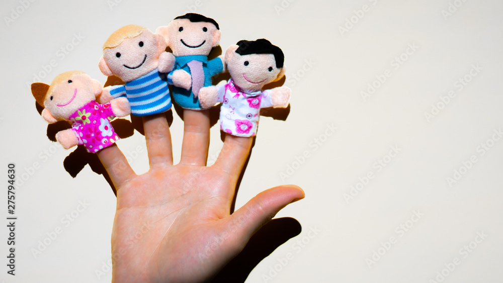 Puppet theater. Hand wearing finger family members puppets: mum, dad ...