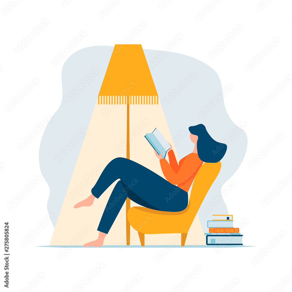 Young adult woman reading book relaxing sitting in chair under lamp and ...