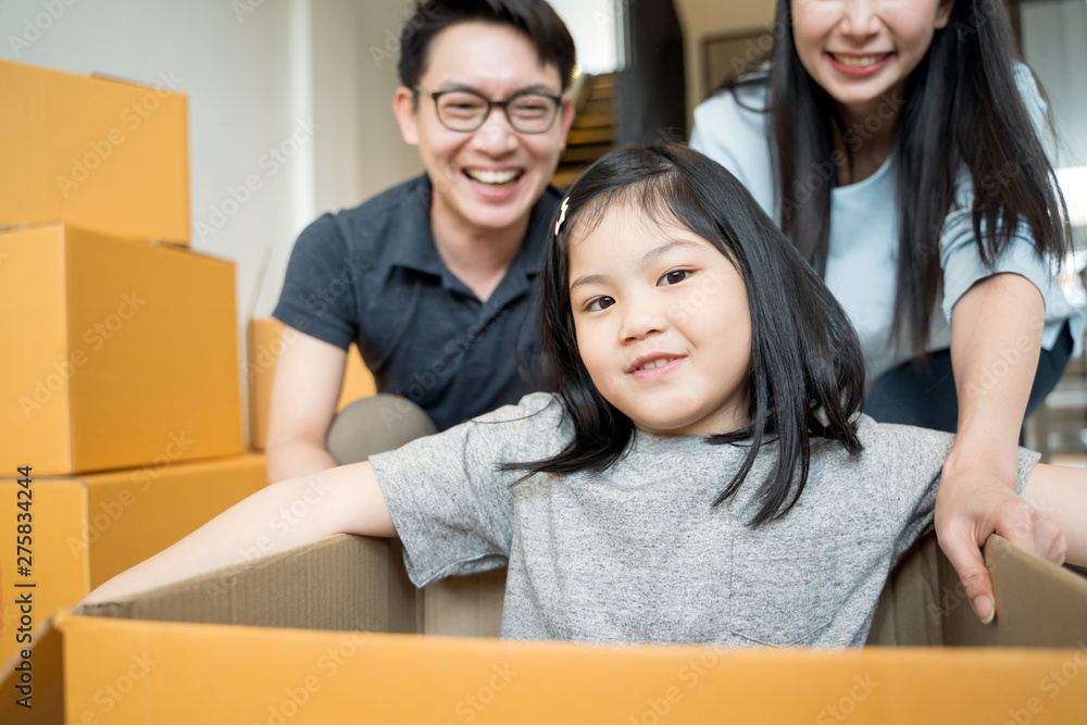 Portrait of happy Asian family moving to new house with cardboard boxes ...