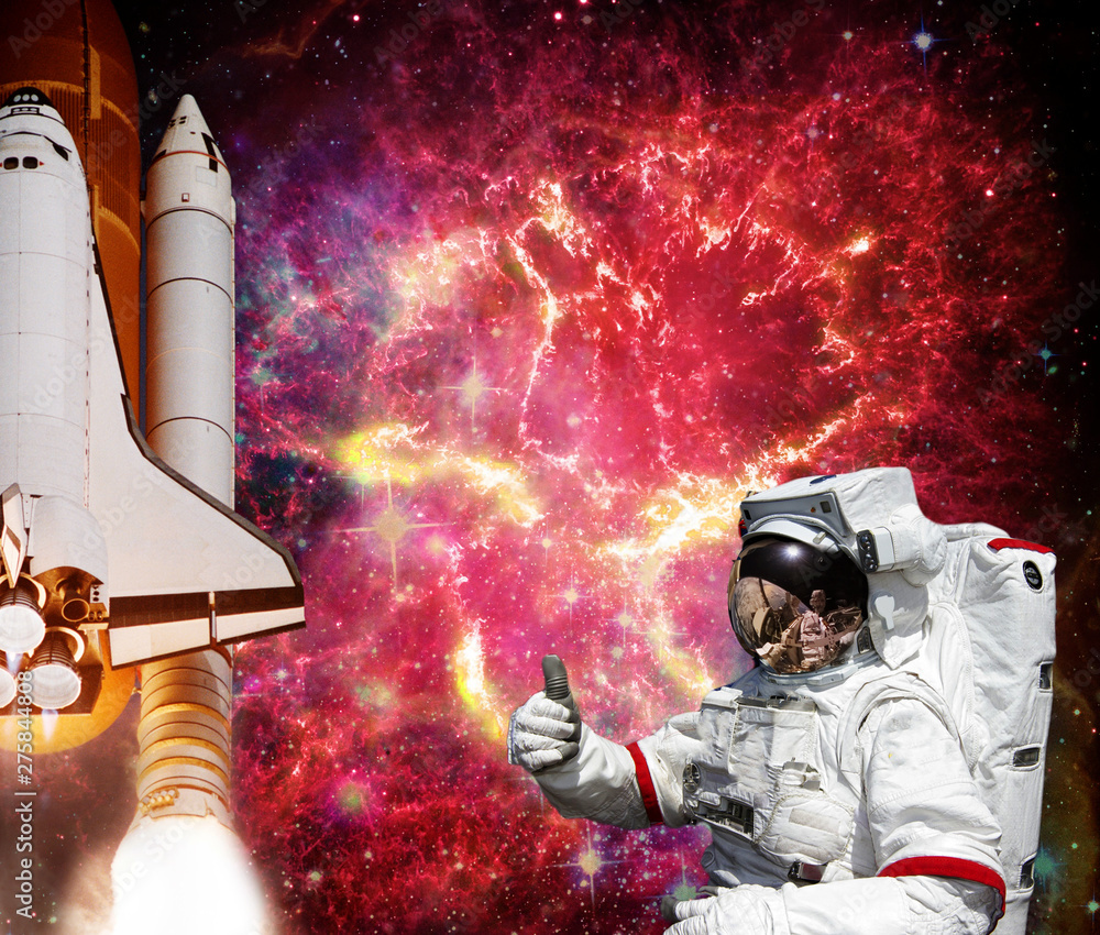 Astronaut gives thumbs-up, rocket and galaxy on the backdrop. The ...