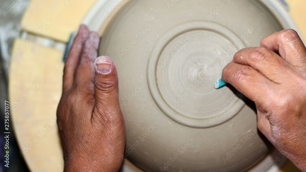 hands of a potter, creating an bowl on the circle, Pottery polishing ...