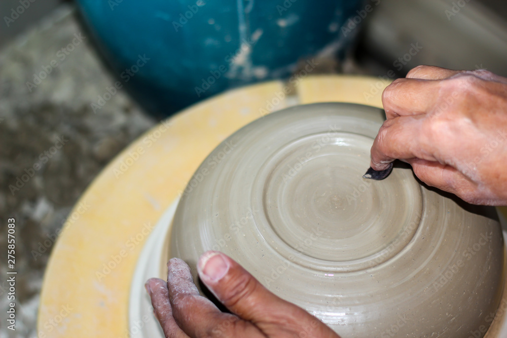 hands of a potter, creating an bowl on the circle, Pottery polishing ...