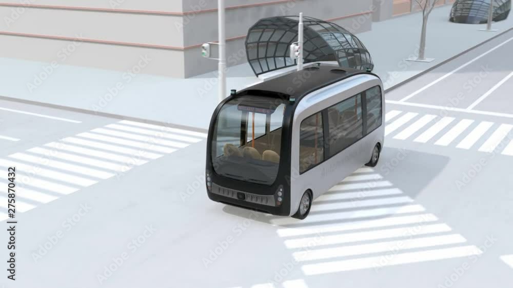 Self-driving shuttle bus driving through an intersection close to bus ...