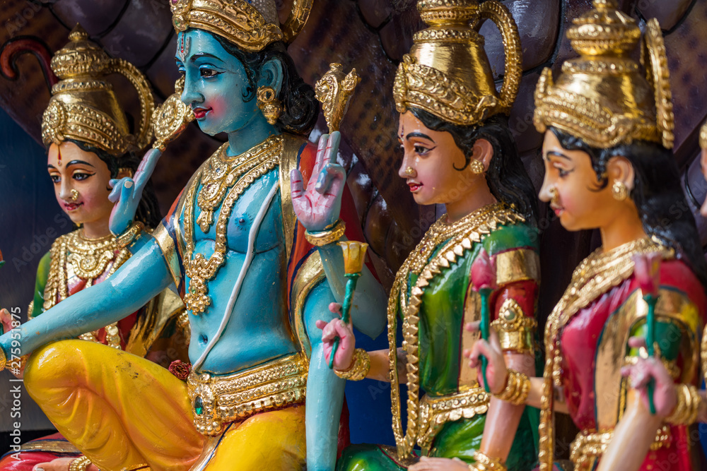 Colourful statues of Hindu religious deities adorning the entrance of a ...