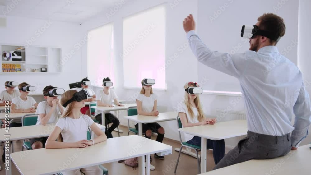Computer science wwith virtual reality at a school lesson. Teacher ...