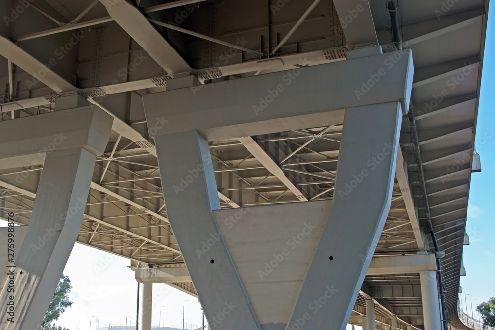 A long, white, curved trestle bridge stretching into perspective ...