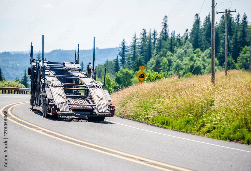 Big rig car hauler semi truck running on the road with empty semi ...