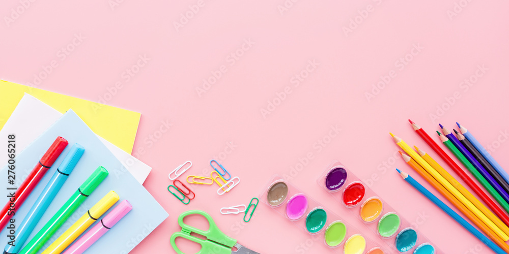 School supplies stationery, colour pencils, paints, paper on pink ...