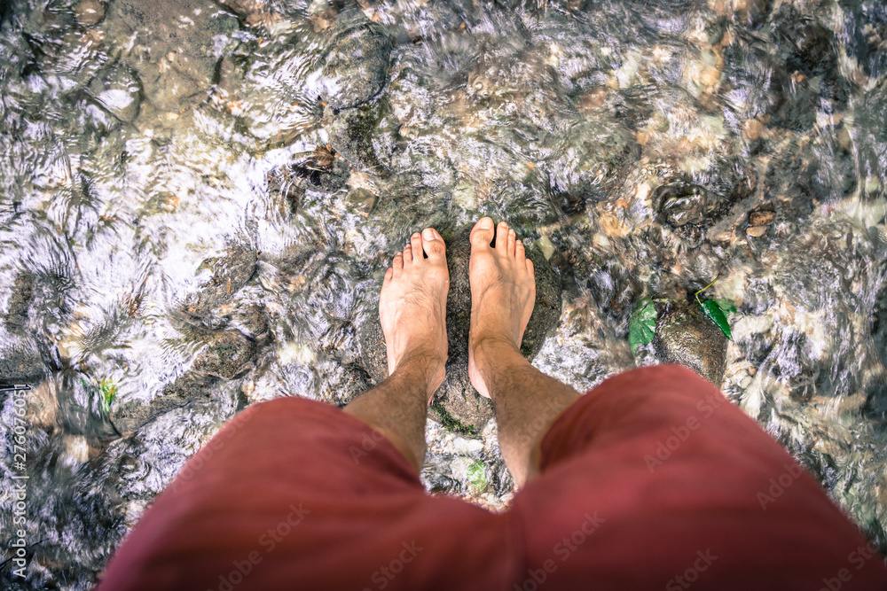 Hiking outdoors in the forest: Cut out of male barefoot feet in a ...